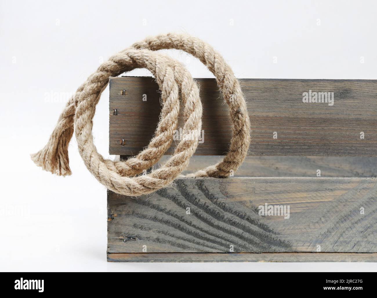 A traditional rope and a wooden box isolated on white background ...