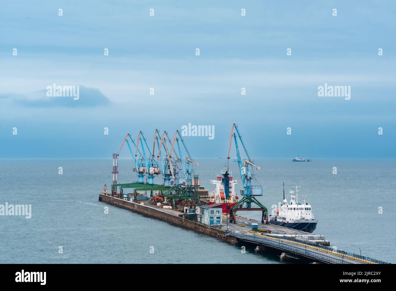 cargo berth with port cranes and moored ships against the backdrop of ...