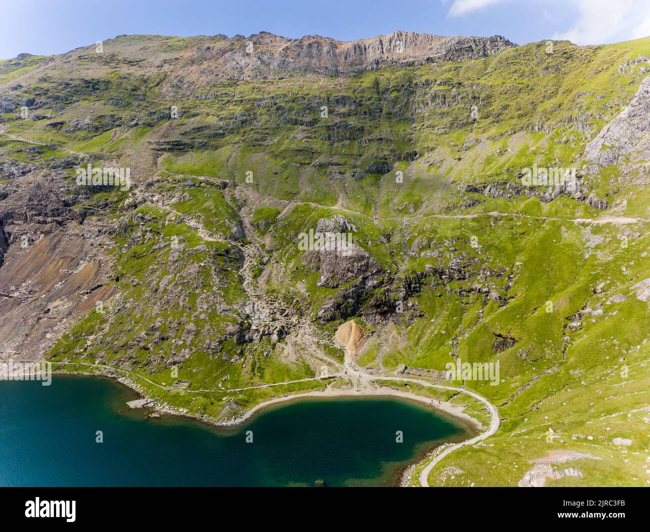 Aerial view of the shoreline of a beautiful mountain lake surrounded by ...