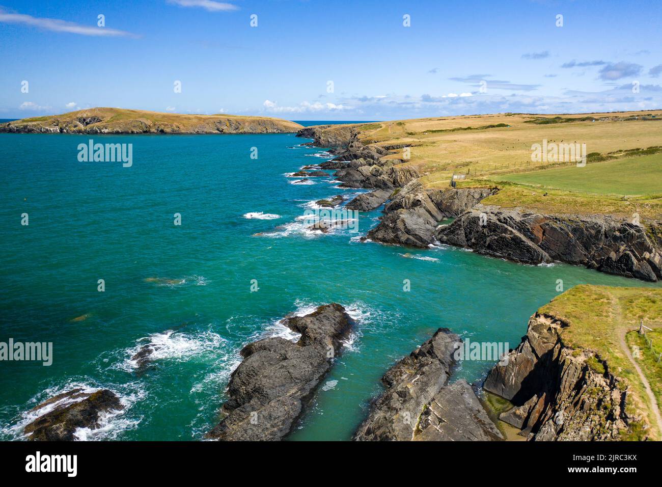 Low altitude aerial view of the rugged Welsh coastline in Pembrokeshire ...