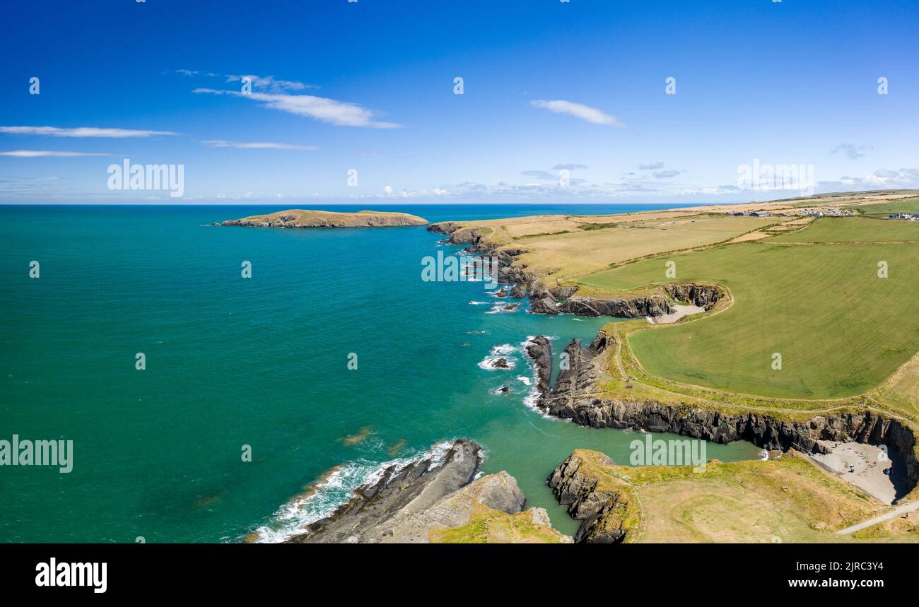 Aerial view of a tiny sandy beach surrounded by cliffs on the coast of ...