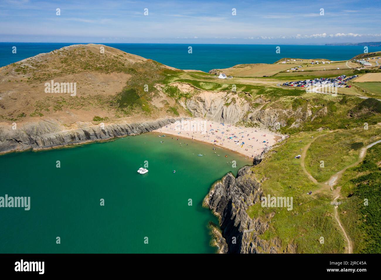 Aerial view of a busy beach and bay in West Wales (Mwnt, Ceredigion ...