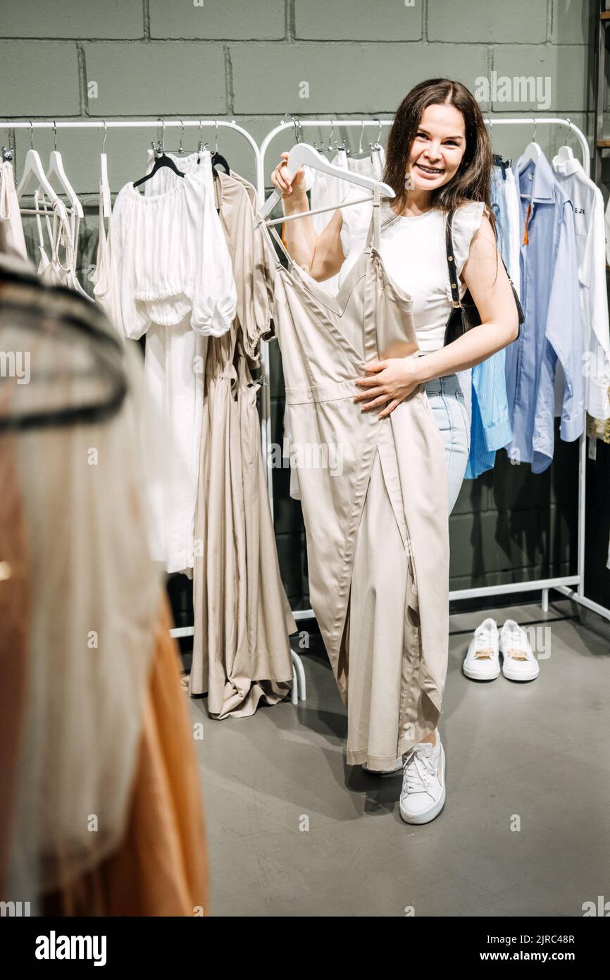 Fast fashion, Woman shopping in cloth store. shopping trendy clothes ...