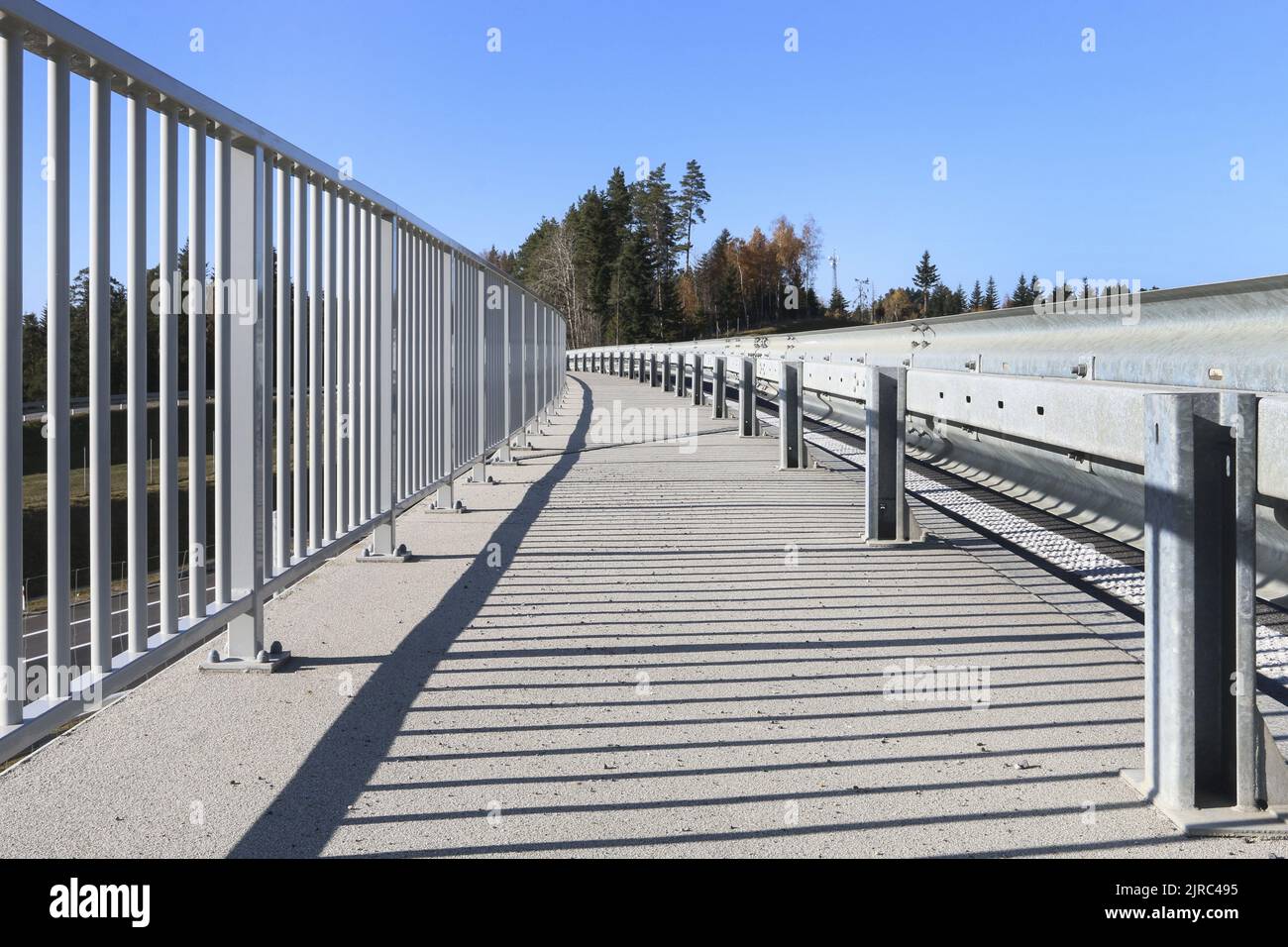 Modern footbridge over the expressway. Industrial landscape Stock Photo ...