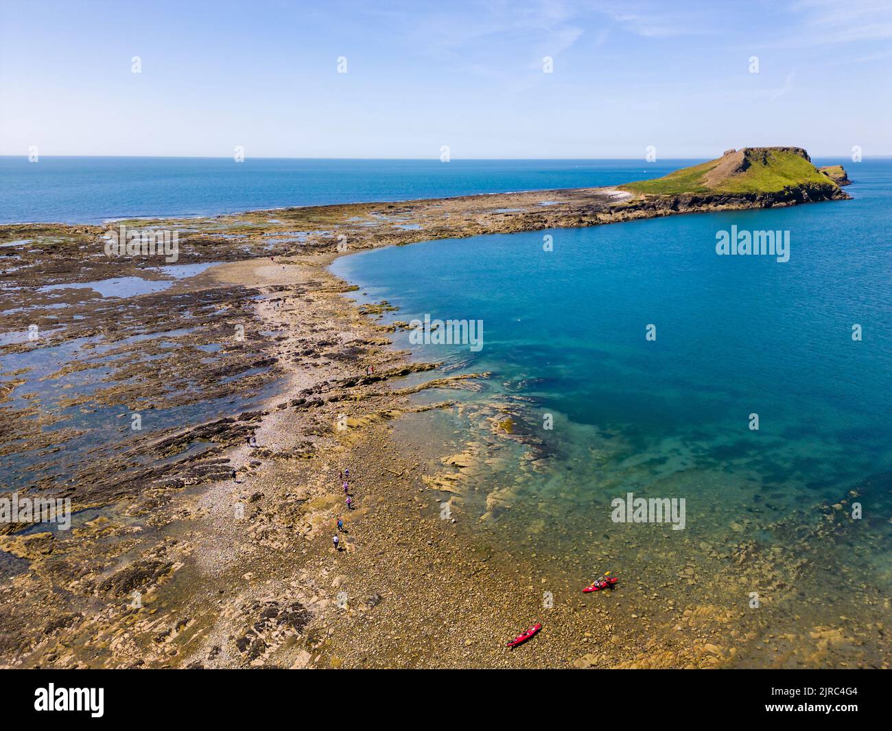 Aerial view of a causeway connecting the mainland to an island at low ...