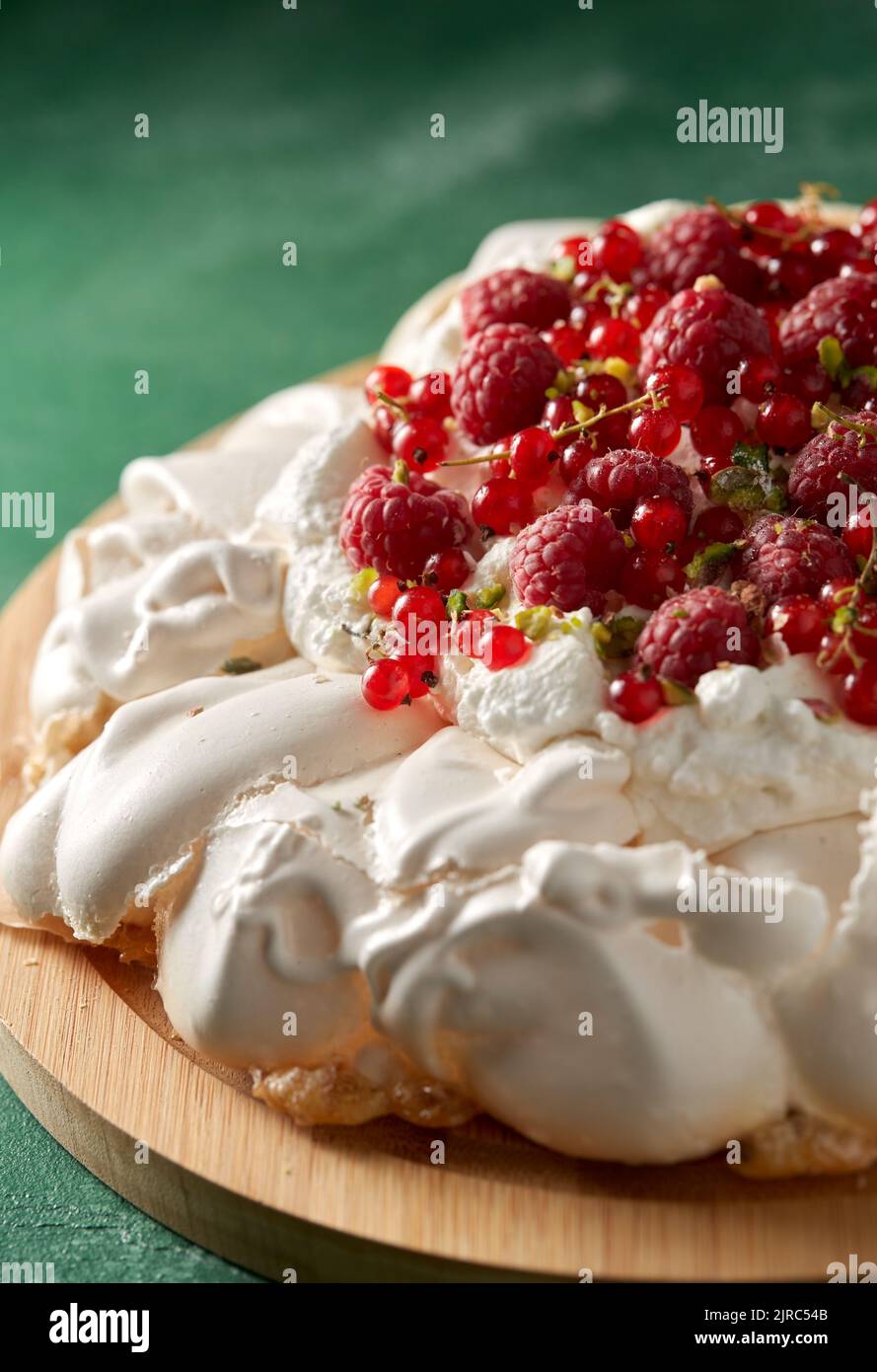 pavlova meringue cake with berries on wooden board Stock Photo - Alamy