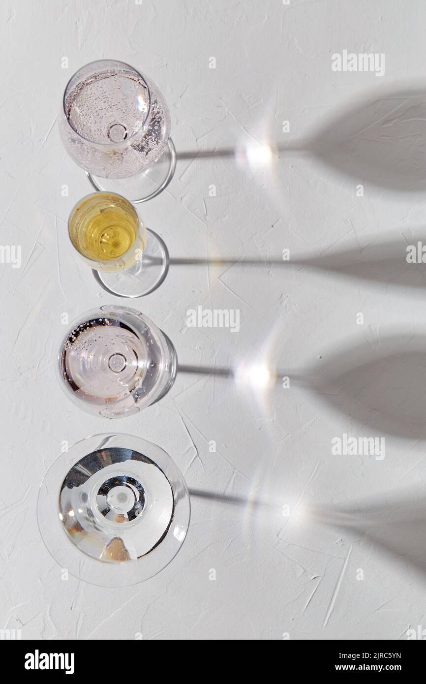 wine glasses dropping shadows on white surface Stock Photo - Alamy