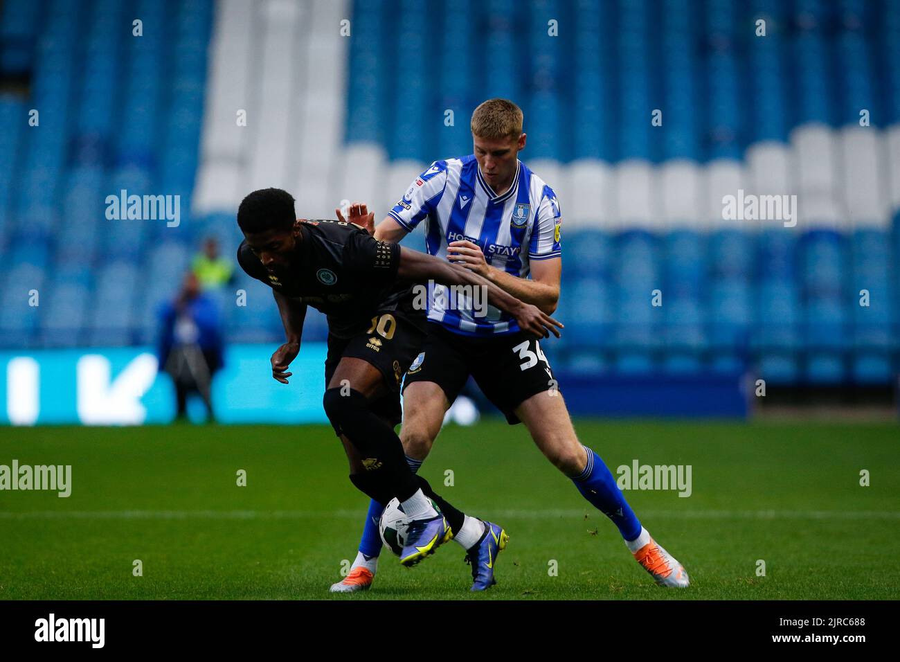 Devante Rodney #10 of Rochdale and Mark McGuinness #34 of Sheffield ...
