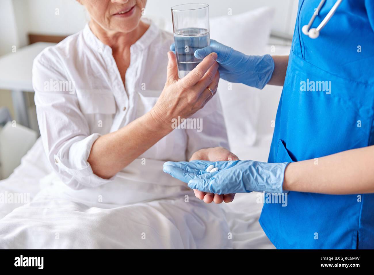 nurse giving medicine to senior woman at hospital Stock Photo - Alamy