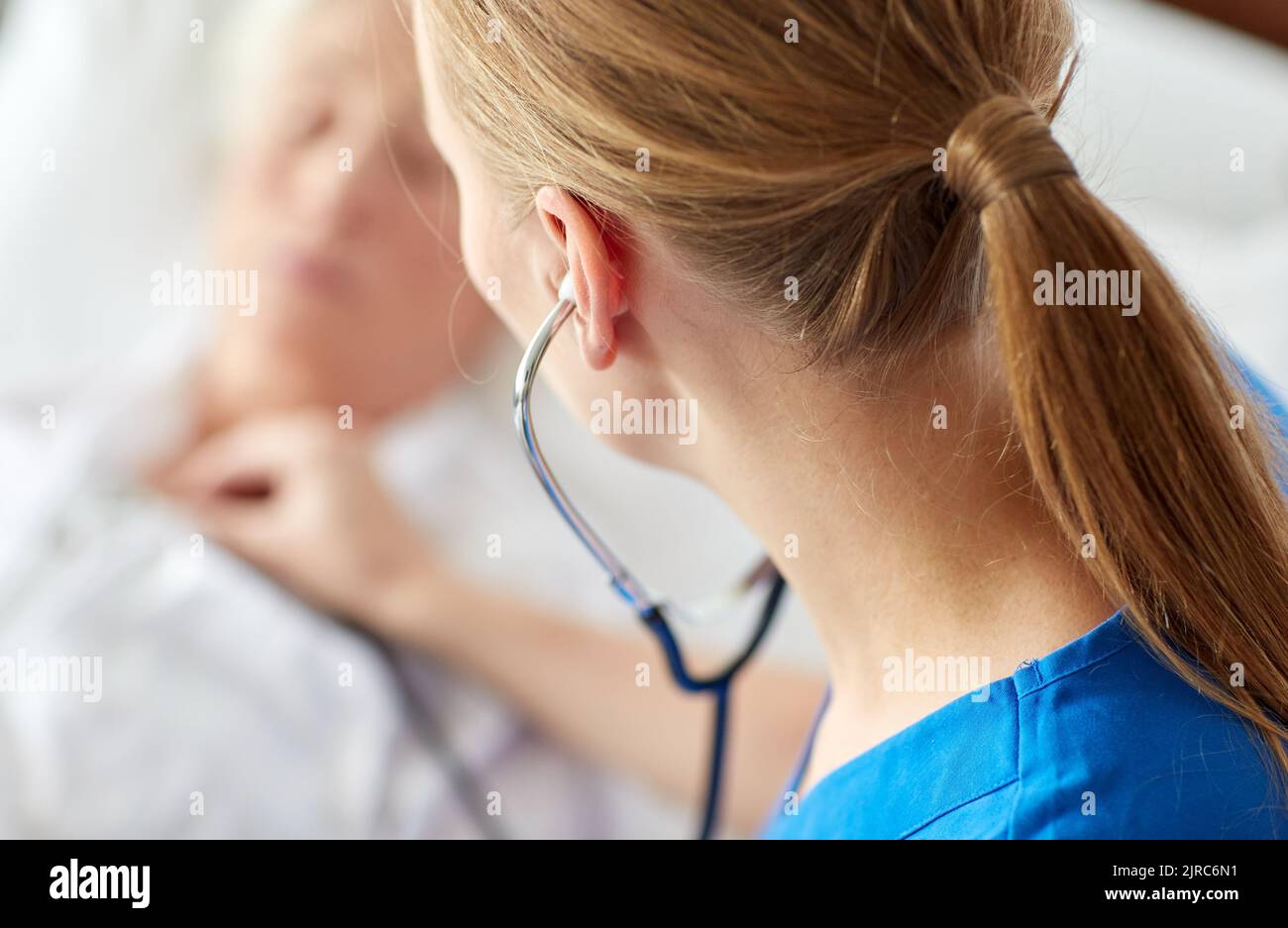 doctor with stethoscope and old woman at hospital Stock Photo - Alamy