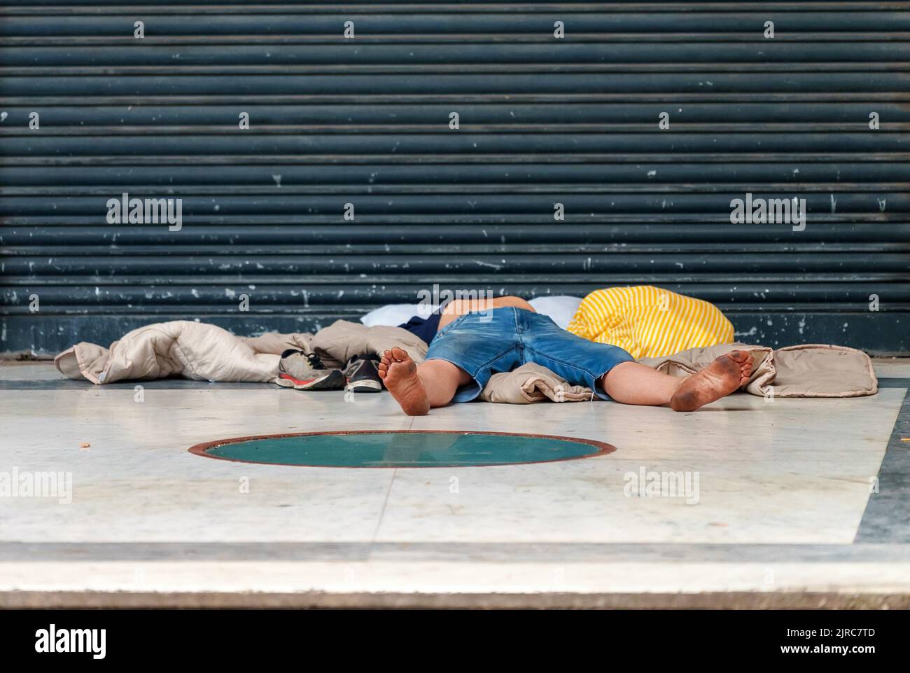 Homeless man sleeping on the street Stock Photo - Alamy