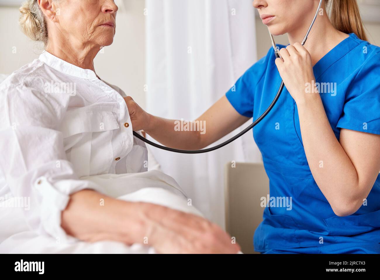 doctor with stethoscope and old woman at hospital Stock Photo - Alamy