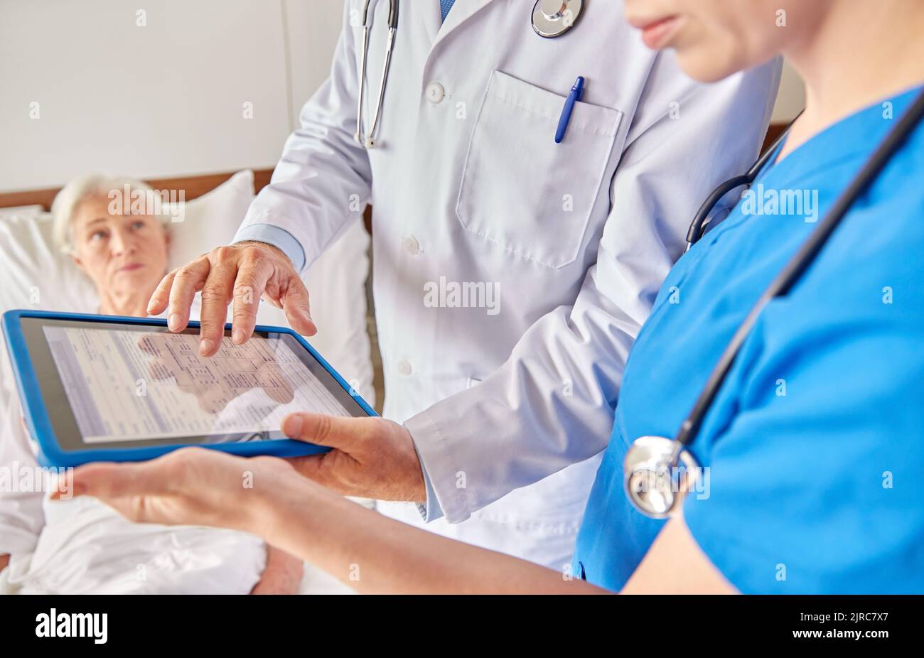 doctors with table pc and senior woman at hospital Stock Photo - Alamy