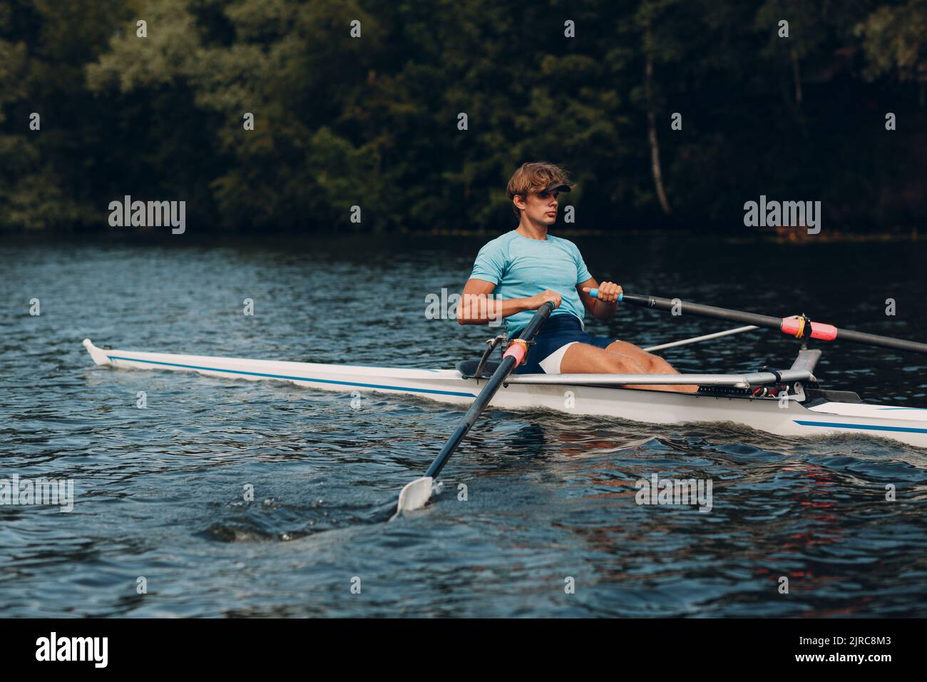 Sportsman single scull man rower rowing on boat. Paddle splash movement ...