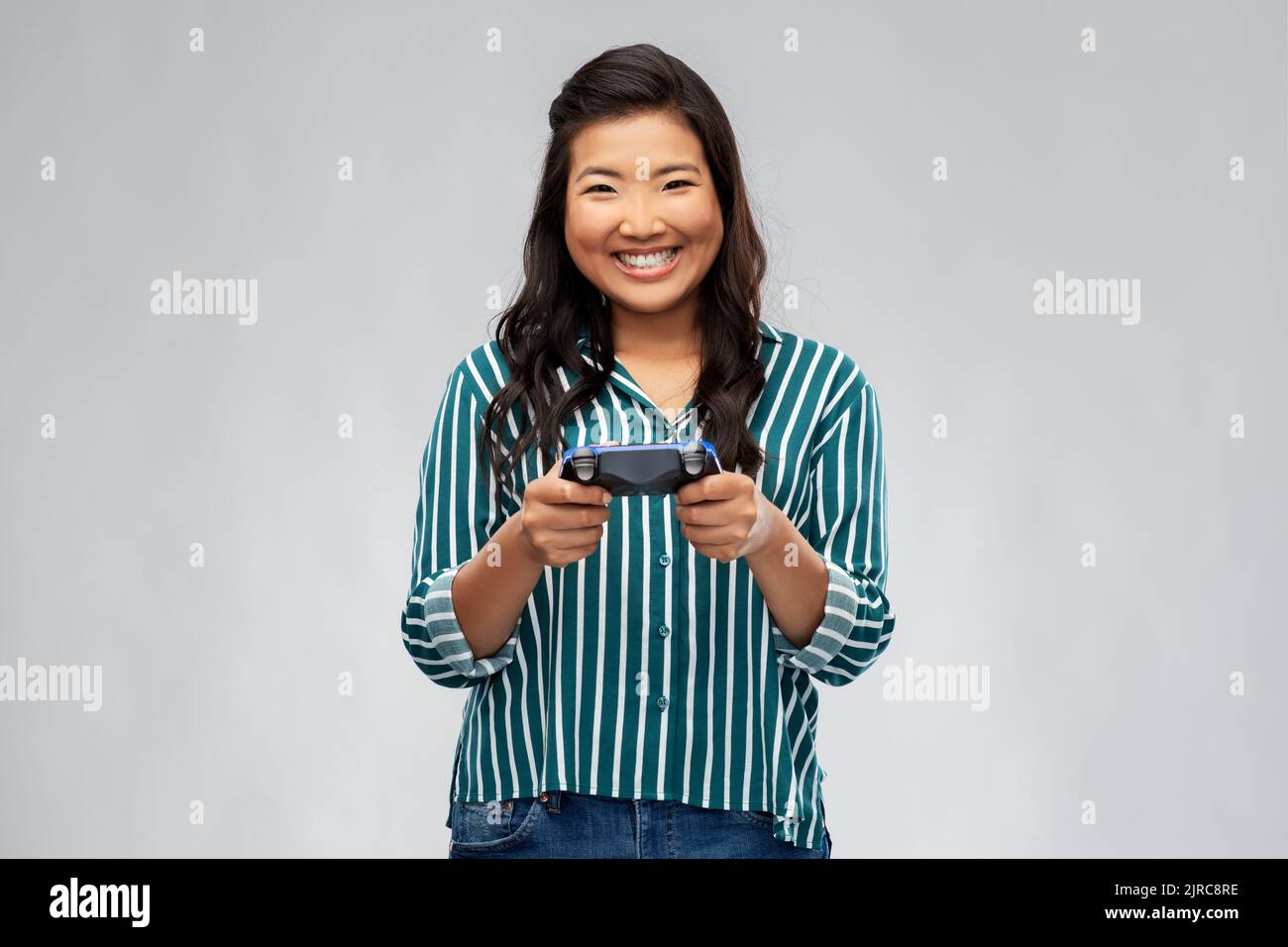 happy asian woman playing video game with gamepad Stock Photo - Alamy