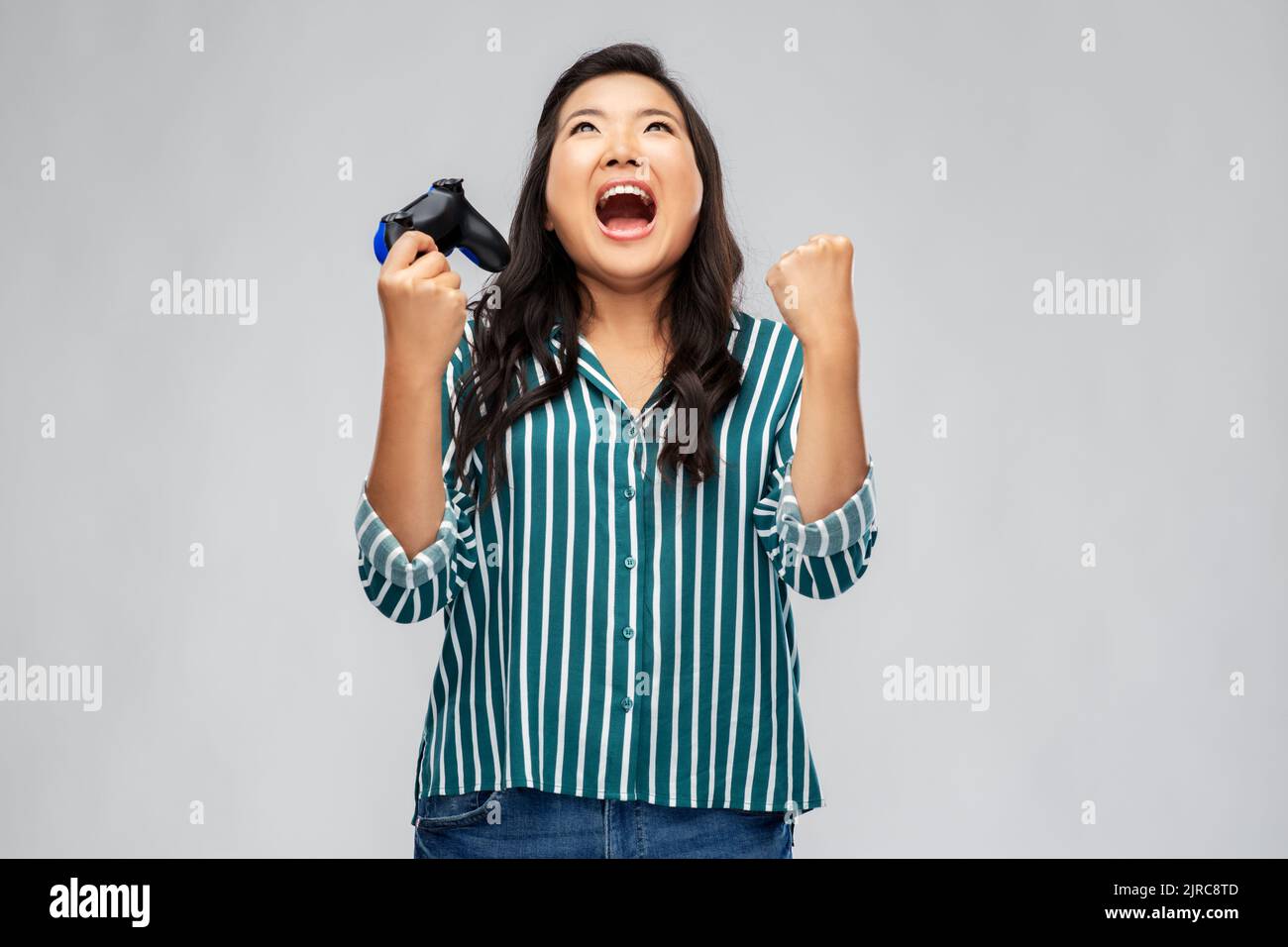 happy asian woman playing video game with gamepad Stock Photo - Alamy