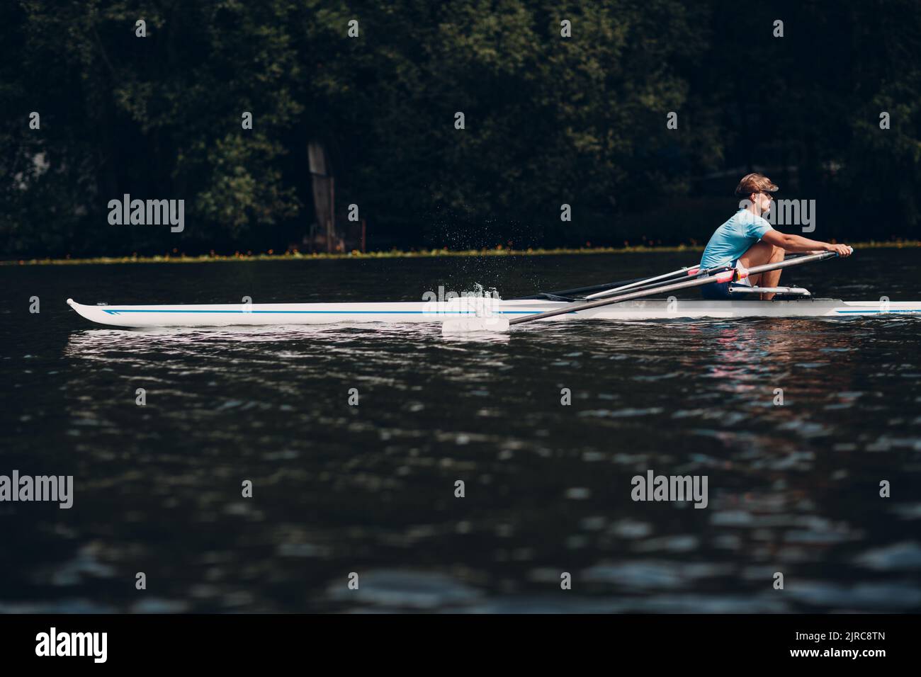 Sportsman single scull man rower rowing on boat Stock Photo - Alamy