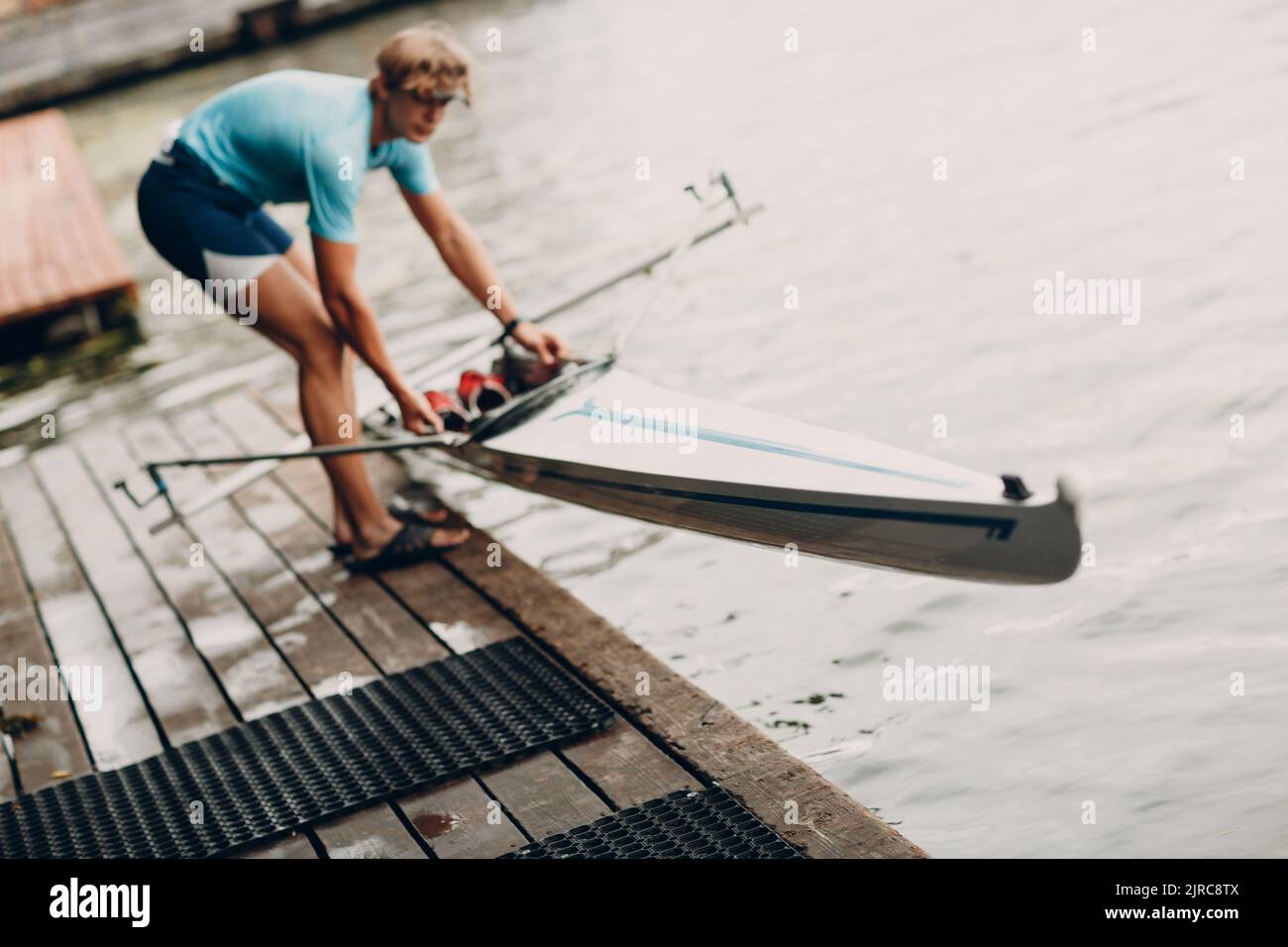 Sportsman single scull man rower carrying boat to competition Stock ...