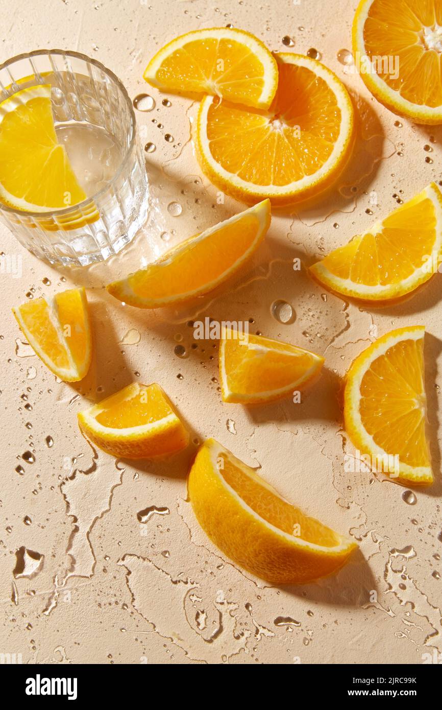 glass of water and orange slices on wet table Stock Photo - Alamy