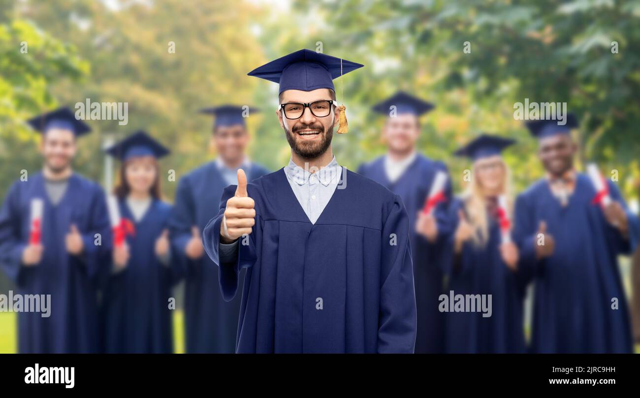 happy male graduate student showing thumbs up Stock Photo - Alamy