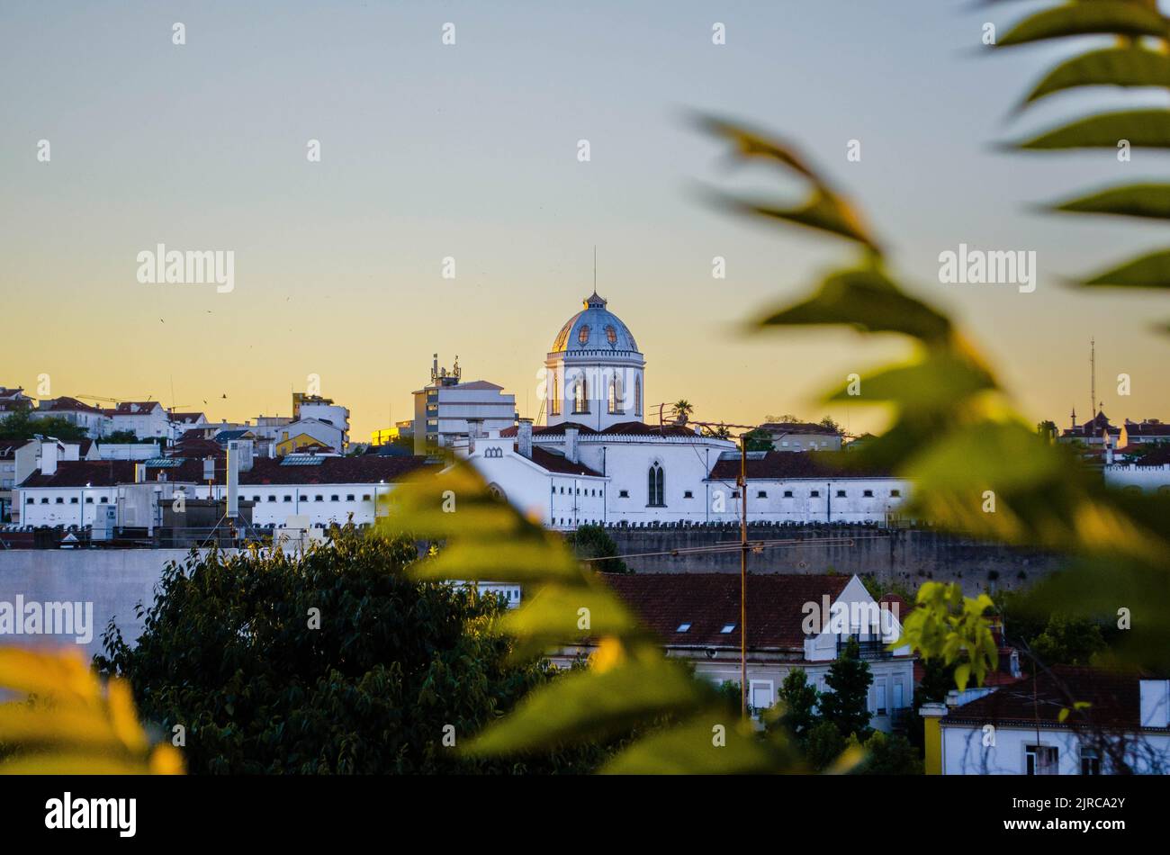The top of Coimbra Prison in the background of the buildings and trees ...