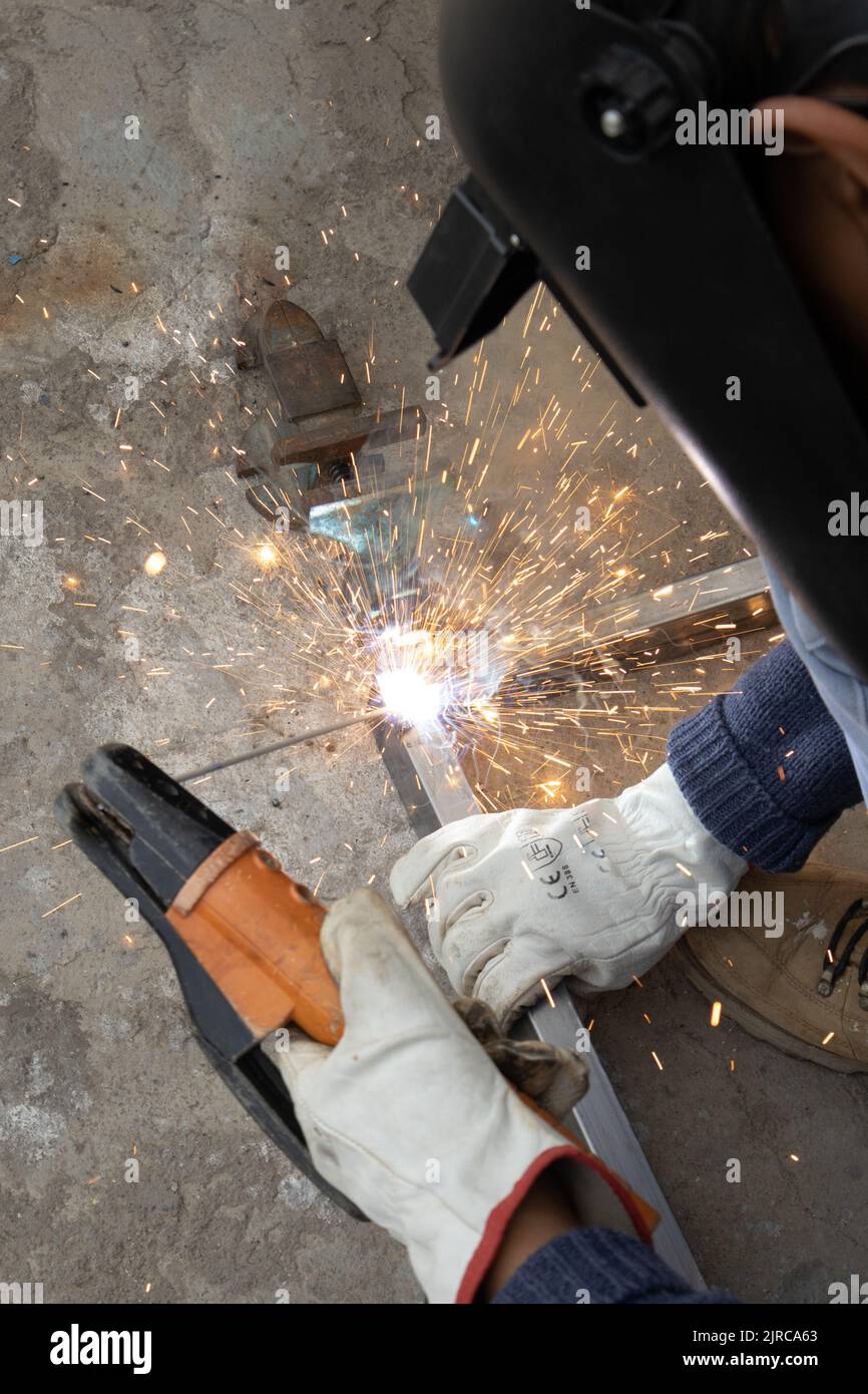 Man welding with his working tools Stock Photo - Alamy