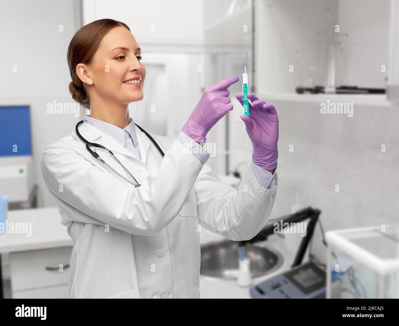 happy female doctor with syringe at hospital Stock Photo - Alamy