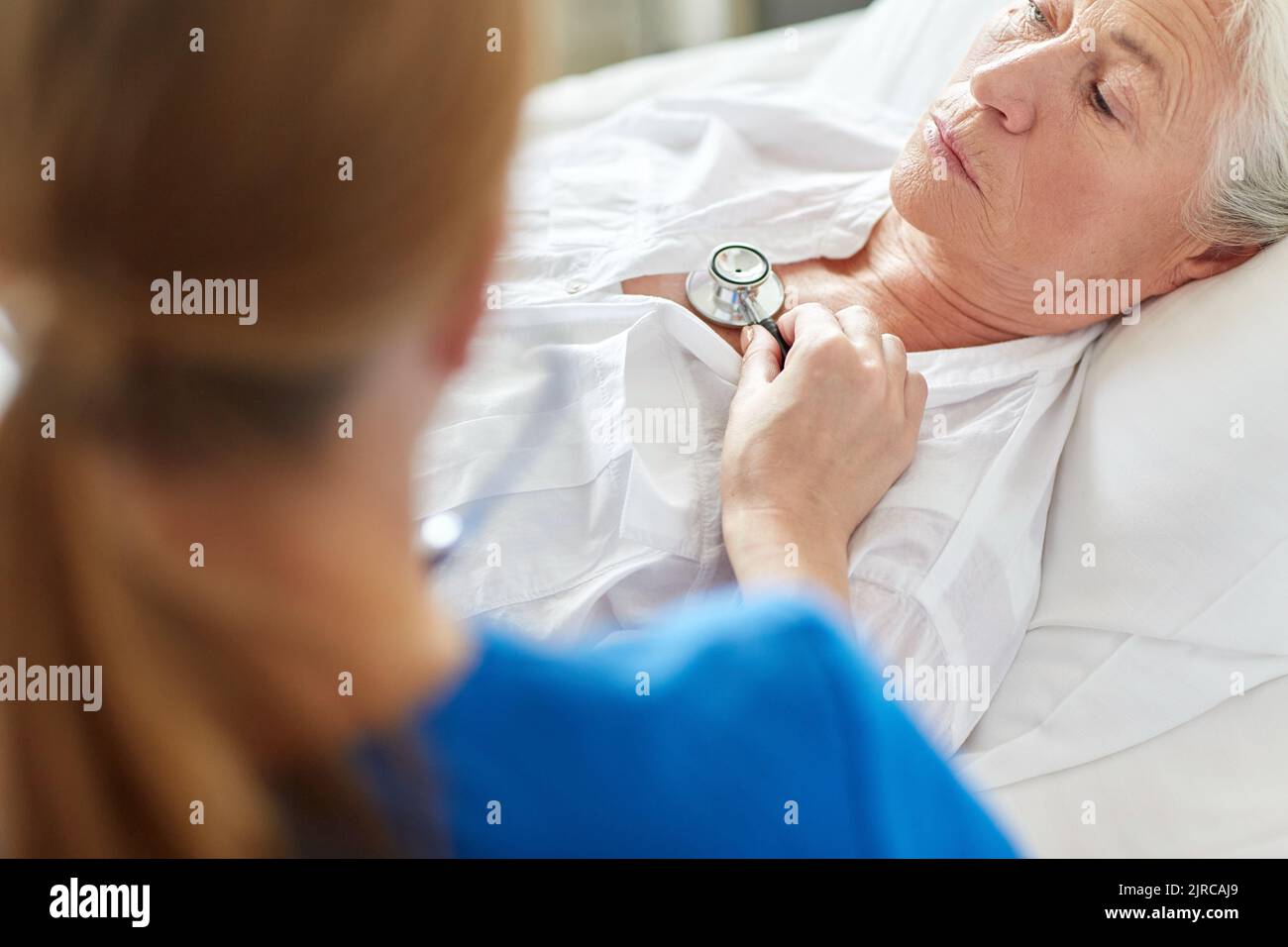 doctor with stethoscope and old woman at hospital Stock Photo - Alamy