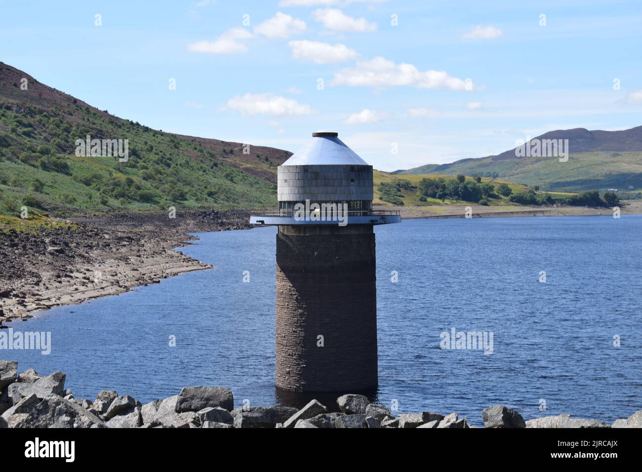 Capel Celyn lake, wales - rocky walk way to the lake with a small tower ...