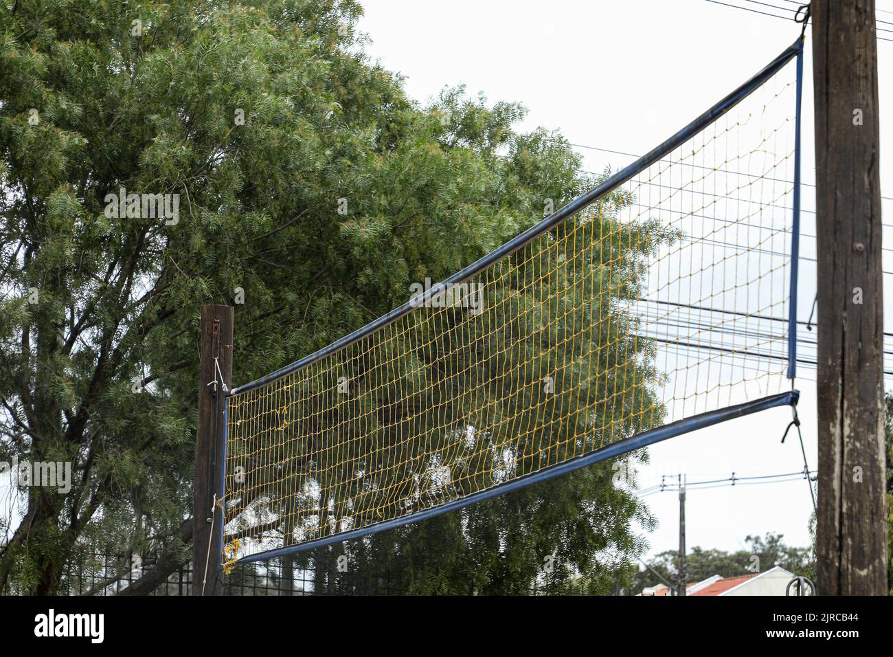 Yellow volleyball net installed in a public place, with a bottom-up ...