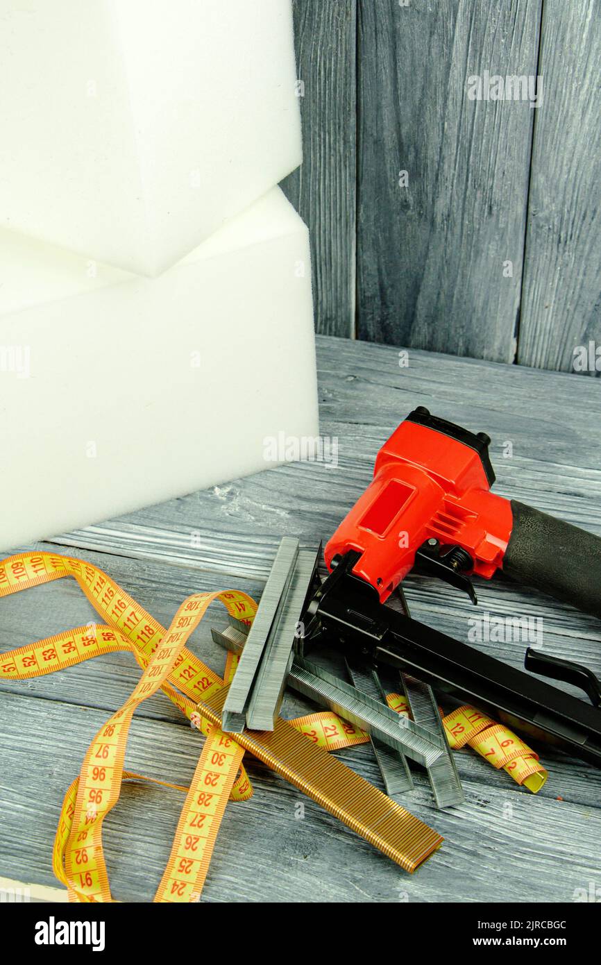 concept of furniture production and repair. Stapler and staples ...