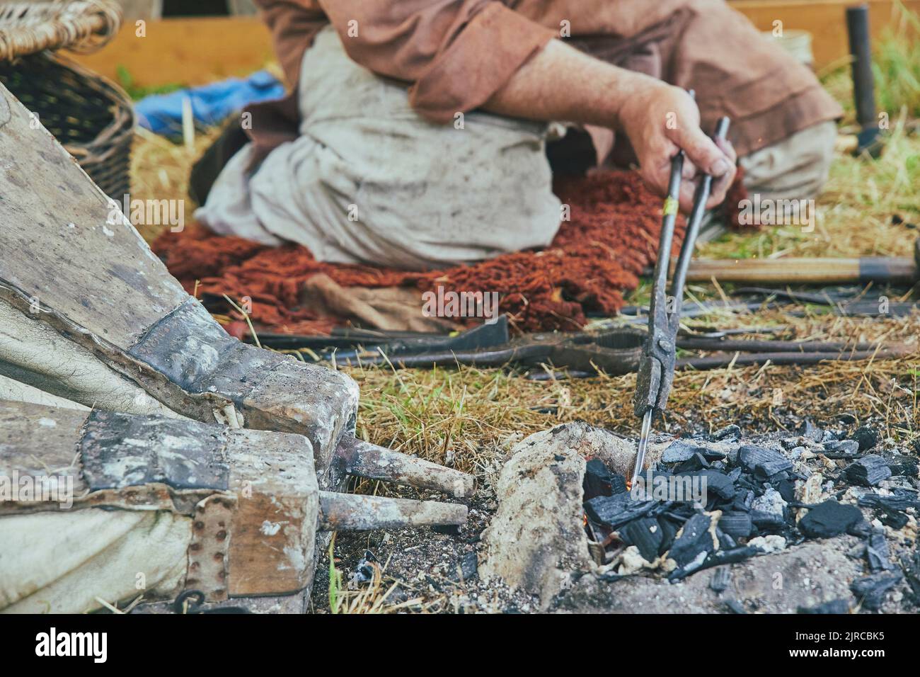 The blacksmith warms up the workpiece with bellows Stock Photo - Alamy