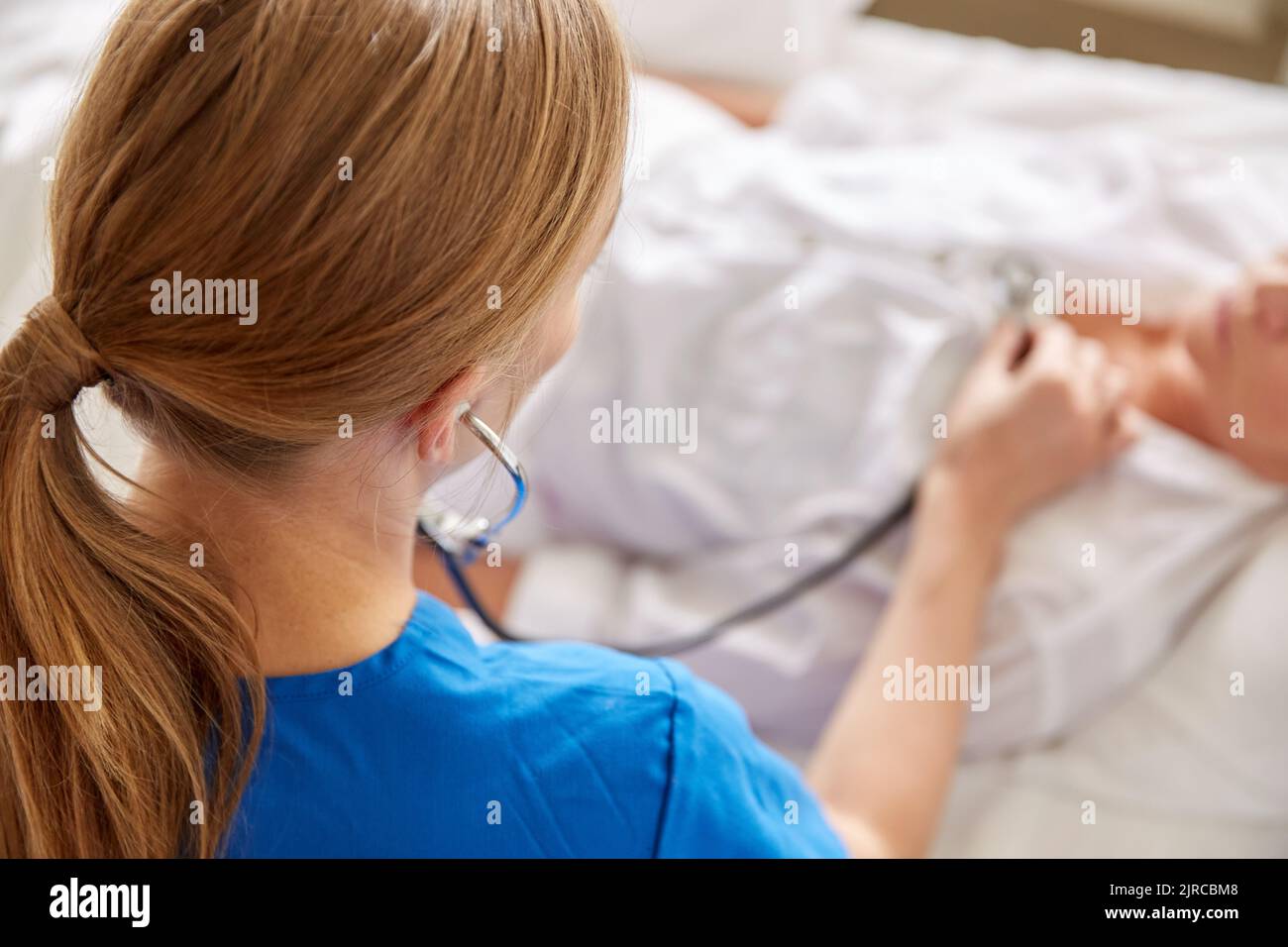 doctor with stethoscope and old woman at hospital Stock Photo - Alamy
