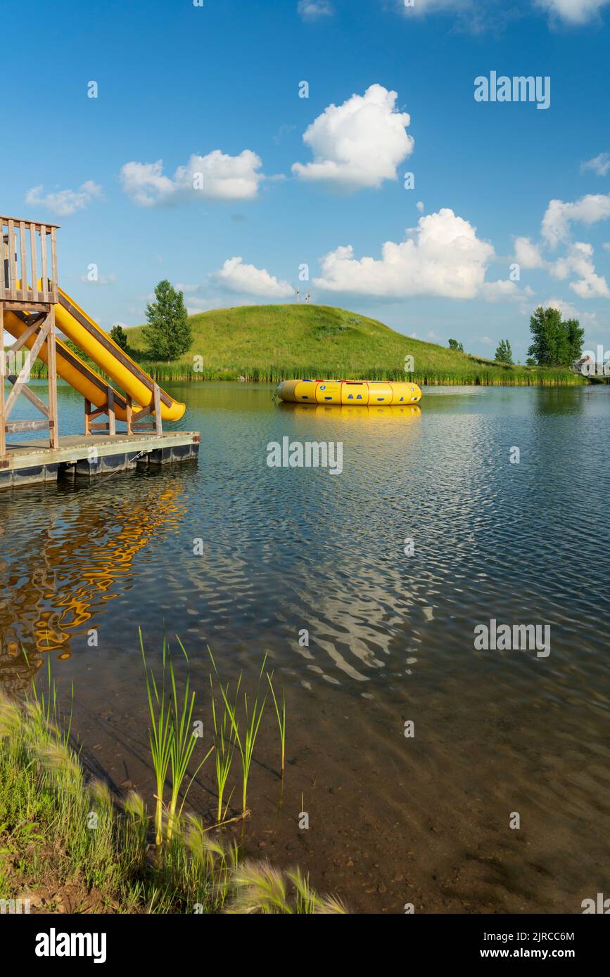 A calm lake with reflections at the Winkler Bible Camp, Winkler ...