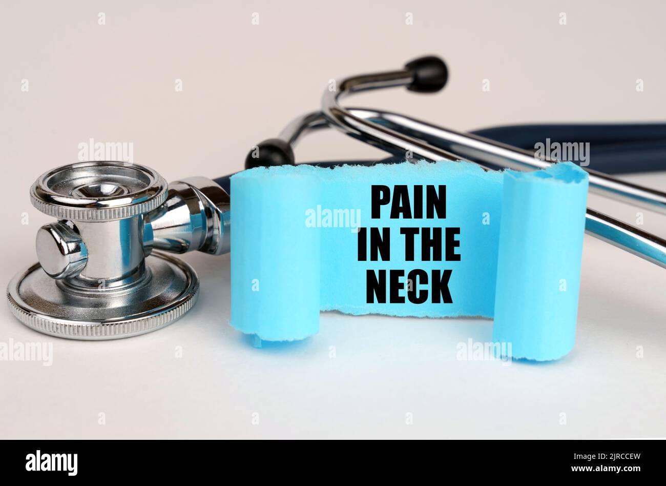 Medical concept. On a white surface lies a stethoscope and a blue roll ...