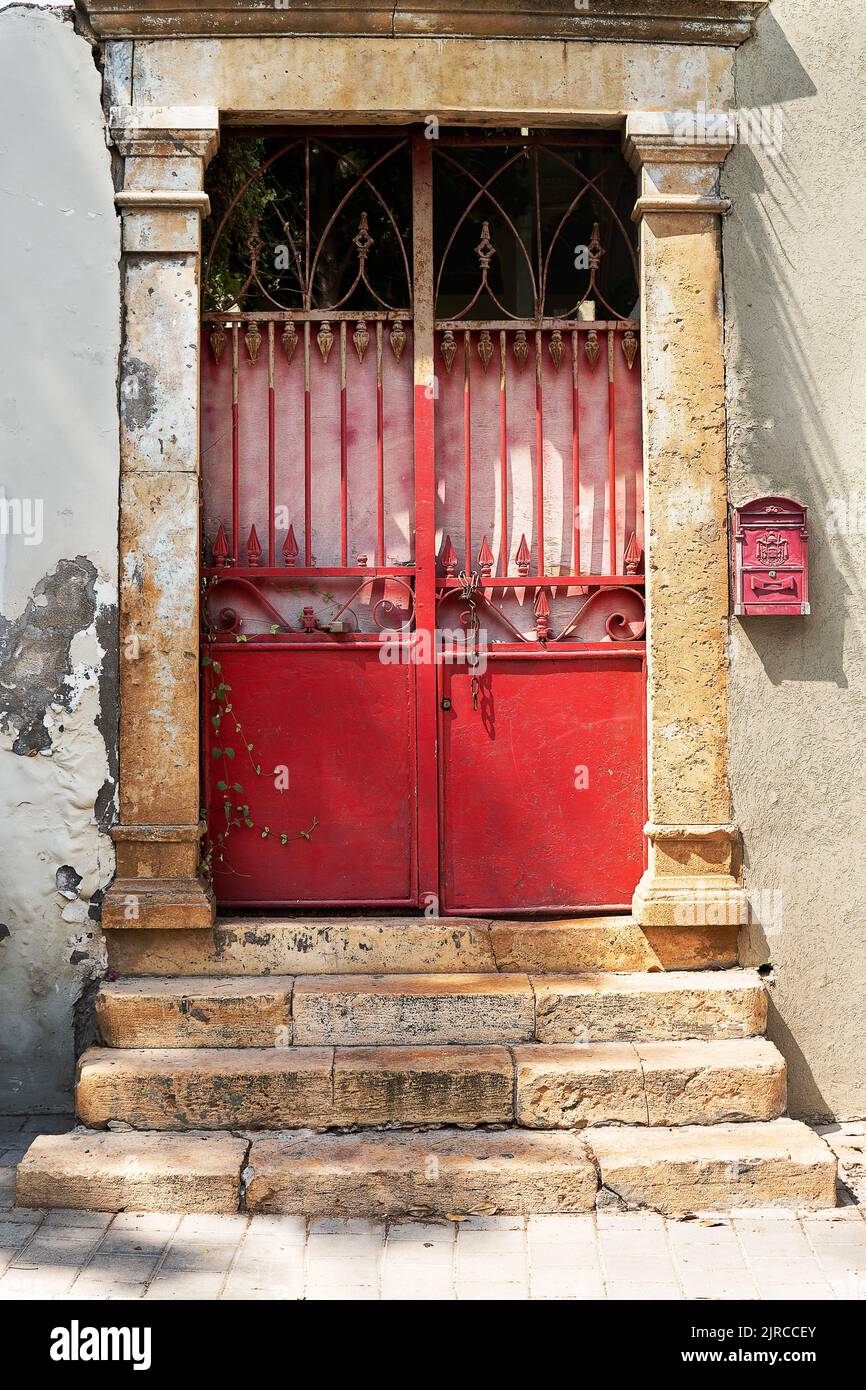 Old metal red doors with stone steps and columns Stock Photo - Alamy
