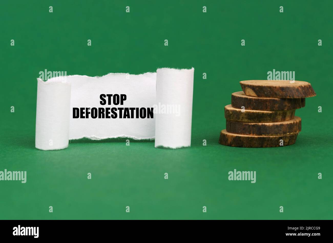 Ecological concept. On a green surface, wooden circles and a white ...