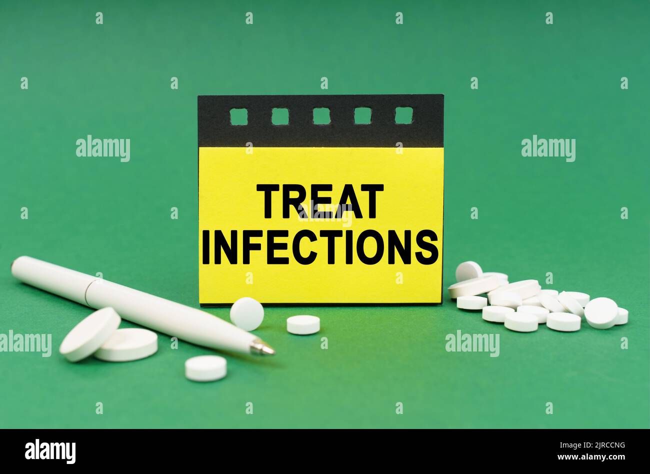 Medical concept. On the green surface are tablets, a pen and stickers ...