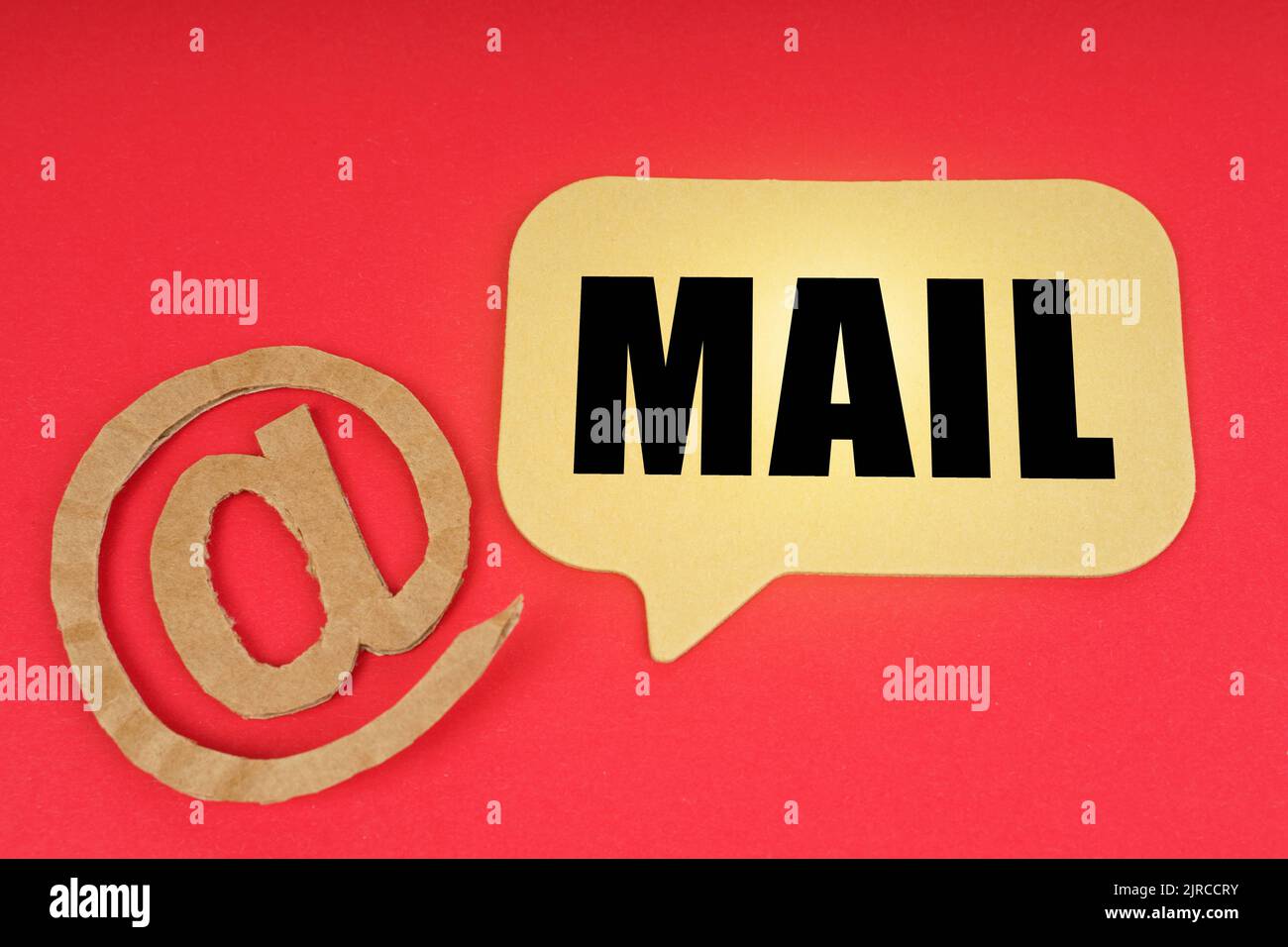 Email and business. On a red surface, a symbol and a sign with the ...