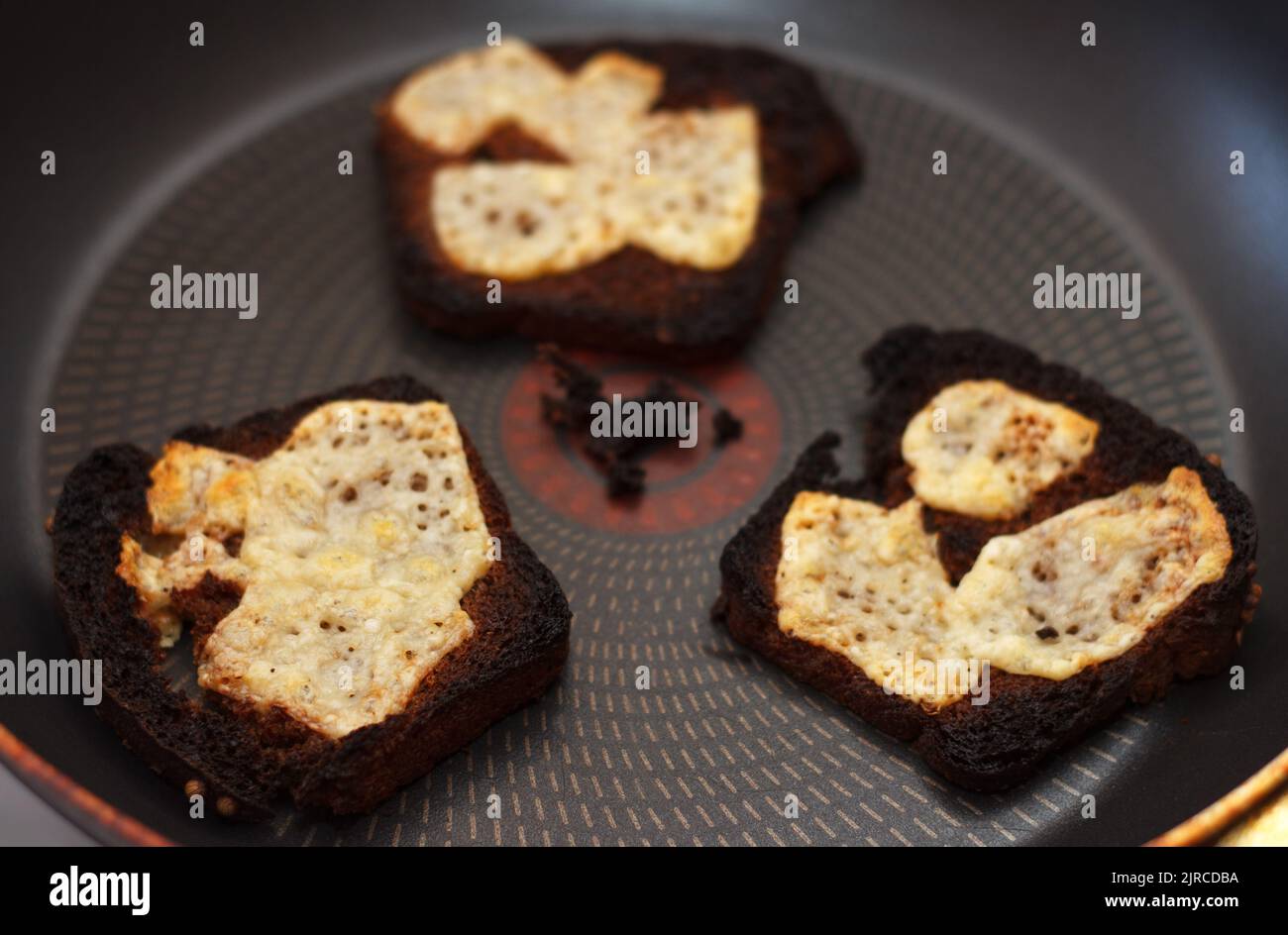 Three cheese sandwiches for breakfast burned in the pan to black Stock ...