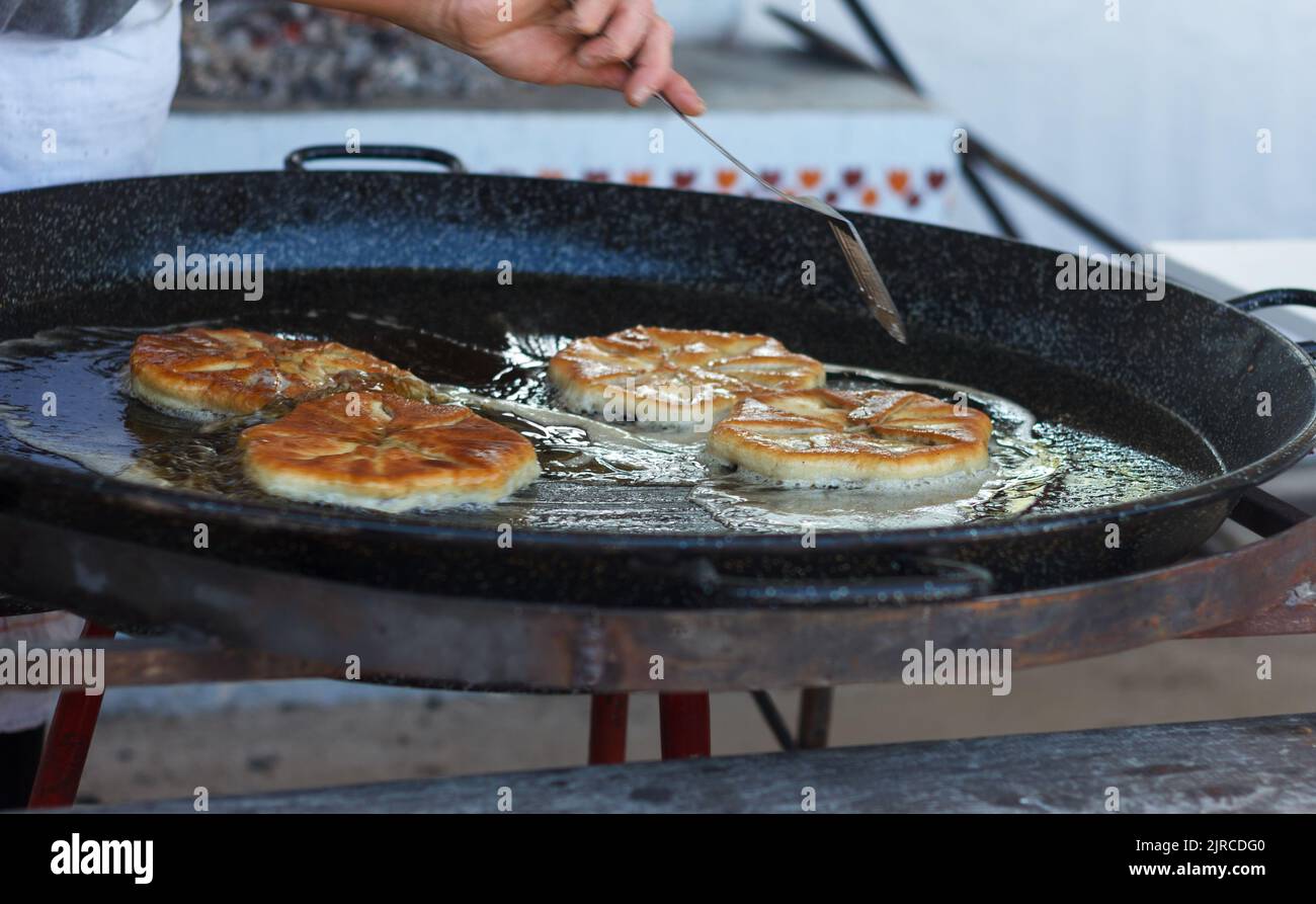 Cook roasts flour pastries in a large pan with butter outdoor Stock ...