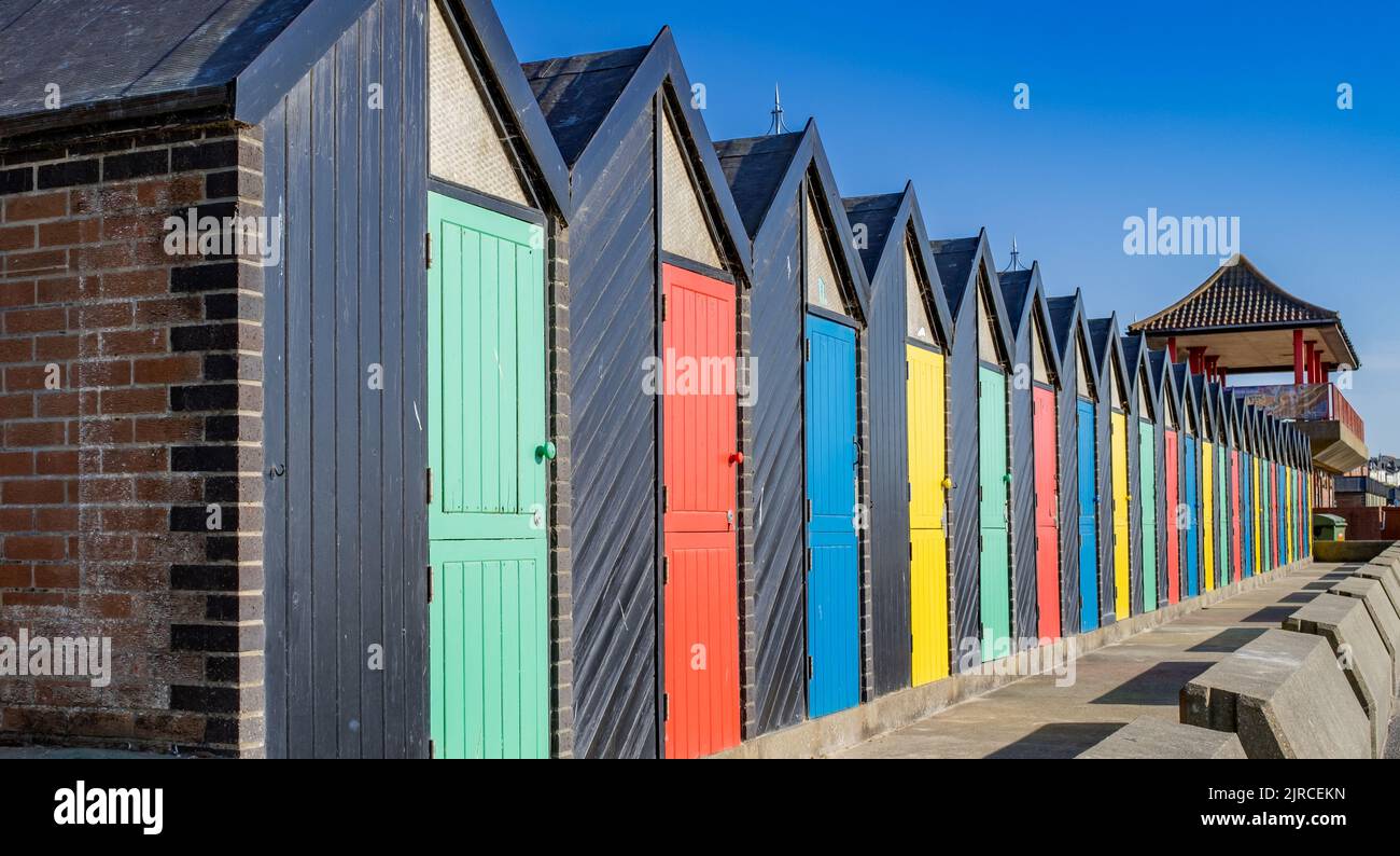 Colourful beach huts on Lowestoft promenade. Captured on a bright and ...