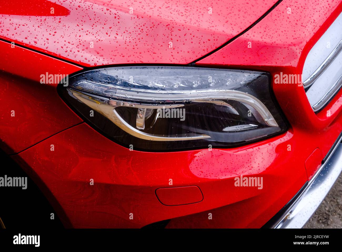 The Headlight of a red Mercedes Benz GLA with dew on it Stock Photo - Alamy