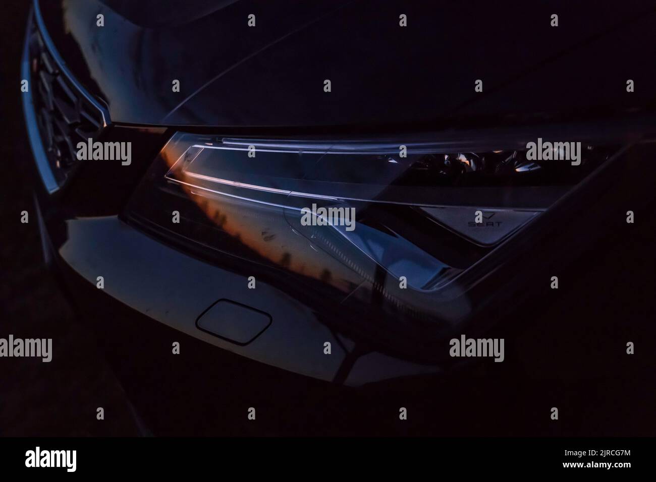 sunset reflecting from car headlight Stock Photo - Alamy