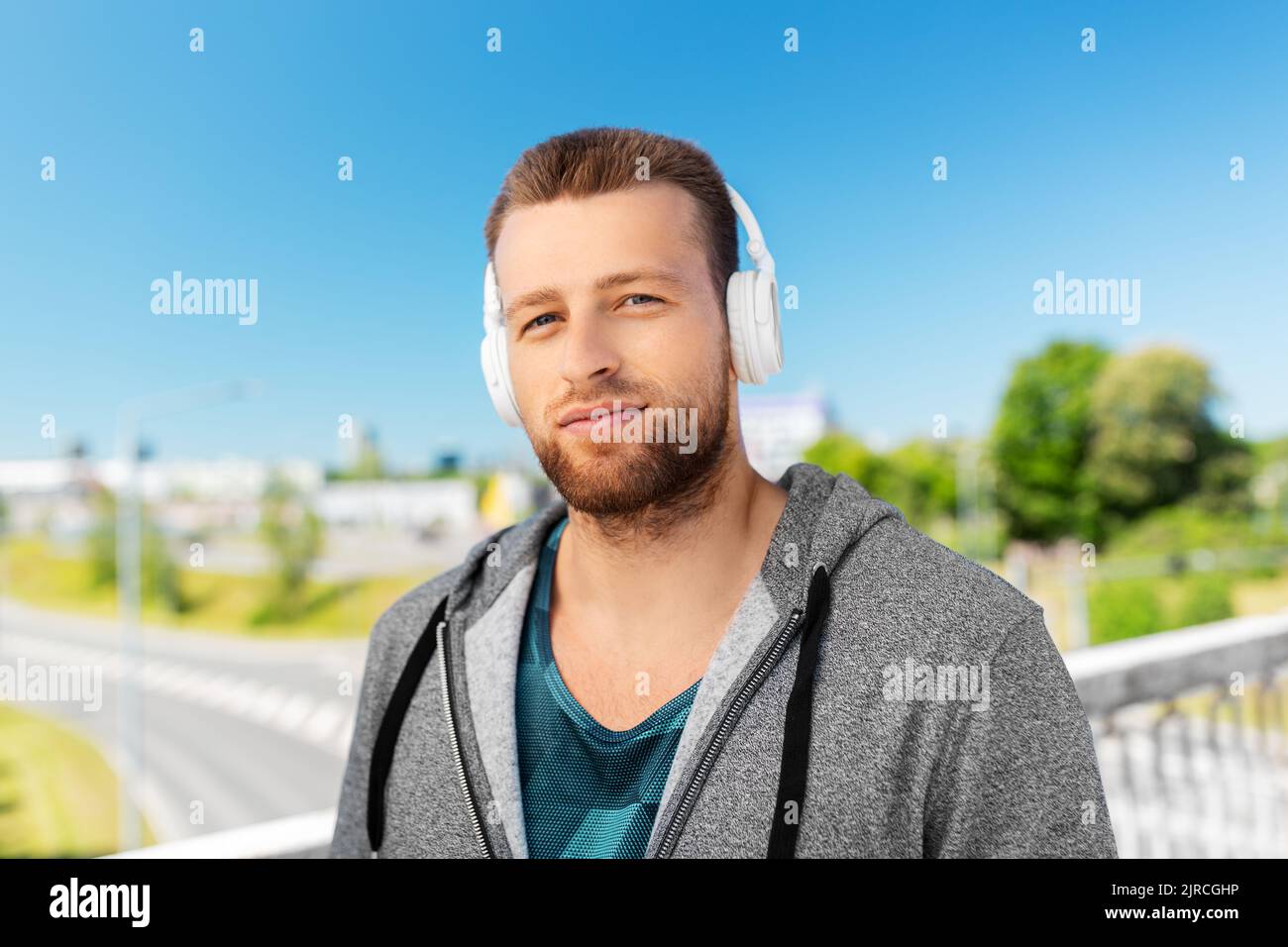 man in headphones listening to music outdoors Stock Photo - Alamy