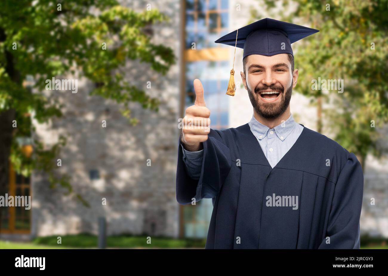 happy male graduate student showing thumbs up Stock Photo - Alamy