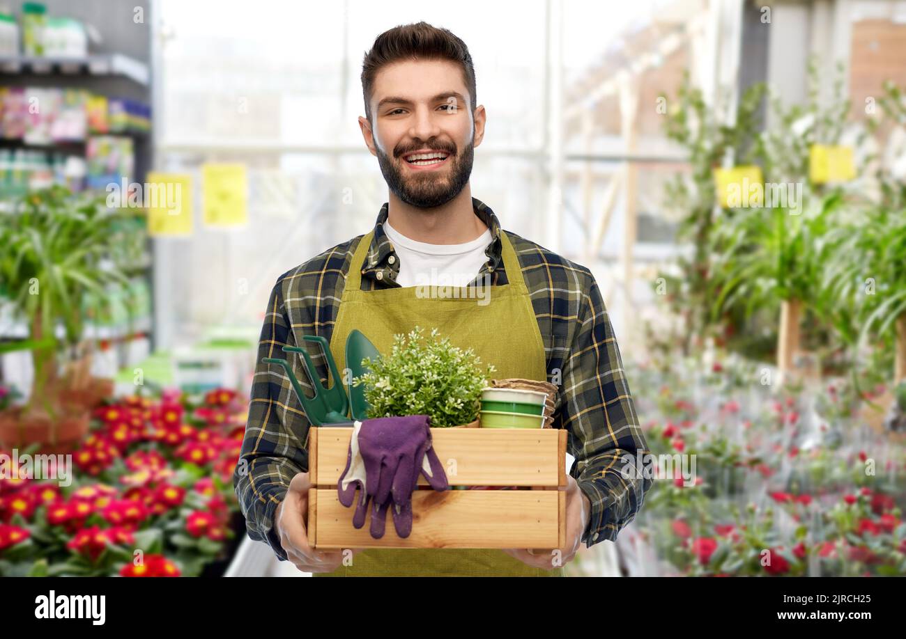 happy gardener or seller with box of garden tools Stock Photo - Alamy