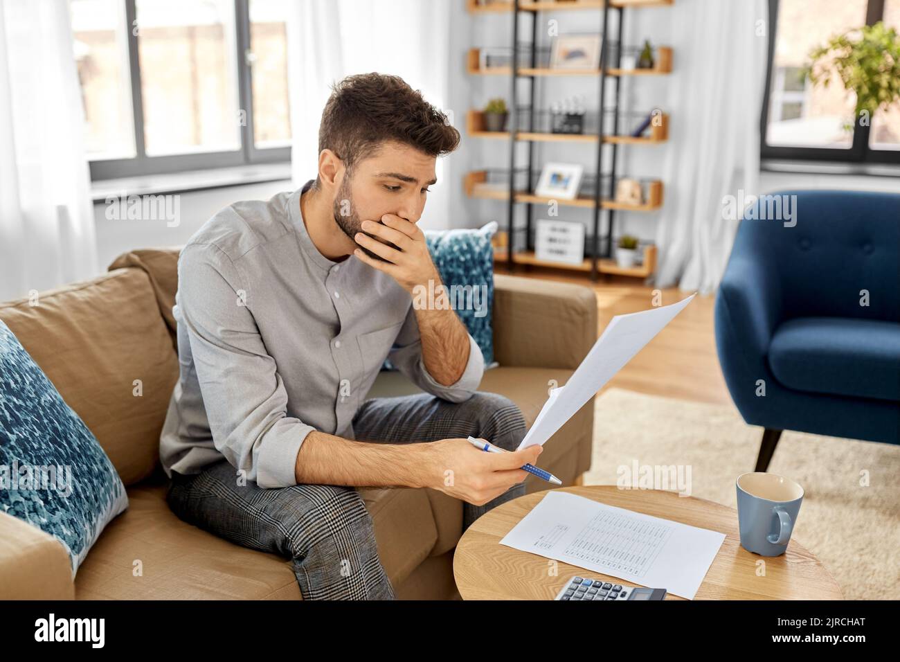 stressed man with bills at home Stock Photo - Alamy