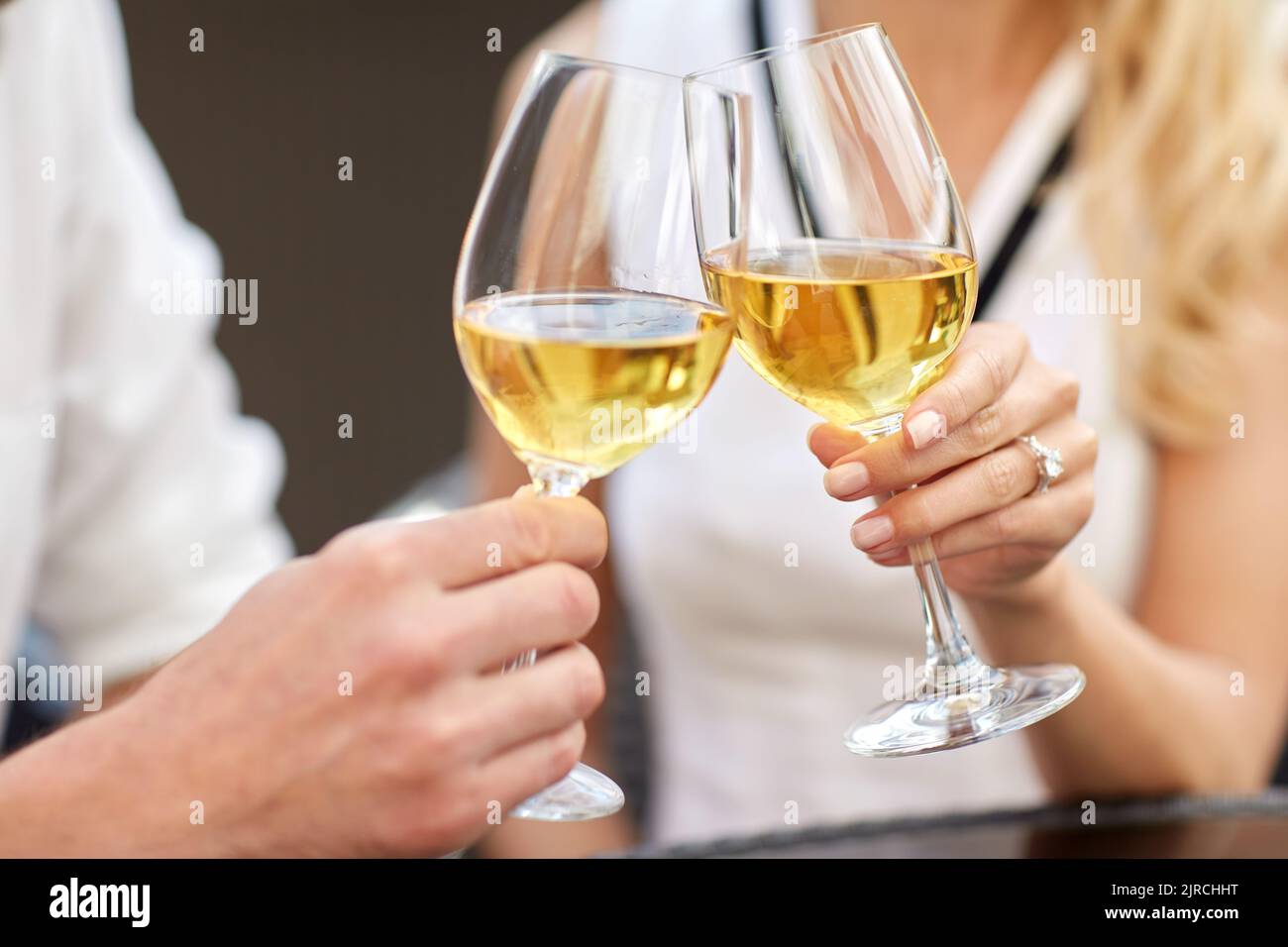 close up of couple clinking wine glasses Stock Photo - Alamy