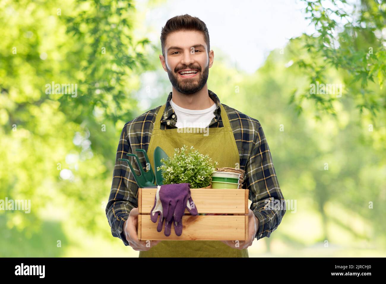happy gardener or farmer with box of garden tools Stock Photo - Alamy